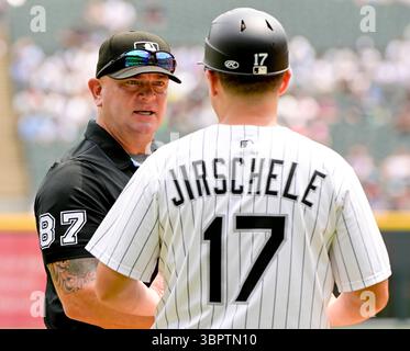 Chicago White Sox third base coach Jeff Cox, left, congratulates Carlos ...