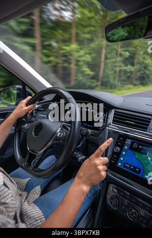 Woman touching a smart car concept on a touch screen with her finger ...
