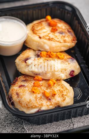 Breakfast, cottage cheese, sour cream banana nuts on a blue wooden ...