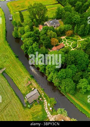 Aerial view of a large rural mansion with a swimming pool in the ...