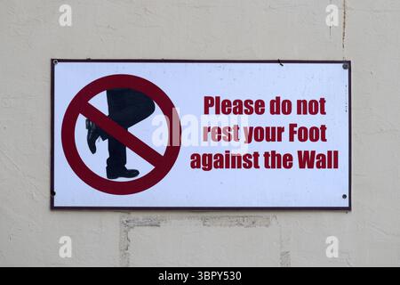 Prohibition sign Please do not lean your foot against the wall, Abu ...