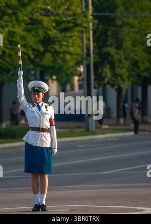 North Korean female traffic security officer in white uniform in the ...