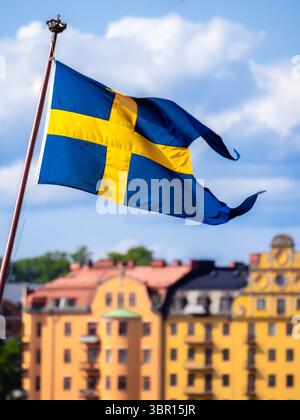 Sweden flag waving with the blue sky on the background Stock Photo - Alamy