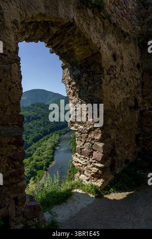 A straight river flowing through a gap in ancient stone defensive walls ...