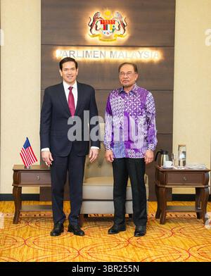 Malaysia's Prime Minister Anwar Ibrahim, right, shakes hands with ...