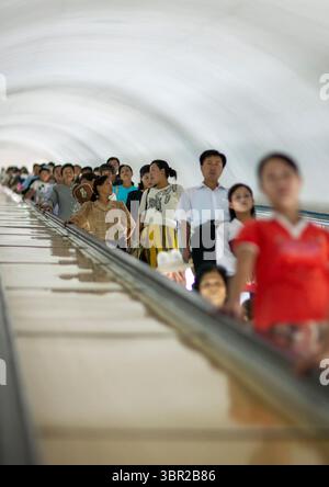North Korean people using escalator leading to the subway station ...