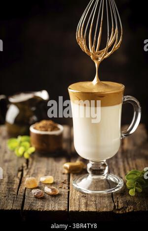 Dalgona Coffee, a cool fluffy whipped coffee in a glass. Latte espresso ...