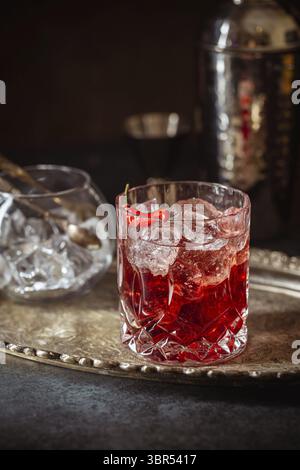 Red alcoholic cocktail with ice and red chili garnish Stock Photo - Alamy