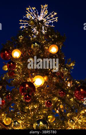 A street, Christmas garland is illuminated against the background of ...