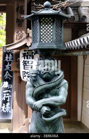 A religious stone statue of Kannon at Japanese buddhism temple Stock ...