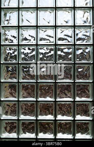 Opaque glass bricks wall with sunlight shinning through. Close up ...