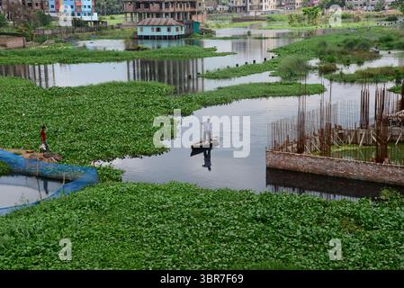 Citizens ride on a boat through flood water at Lowland area of the ...