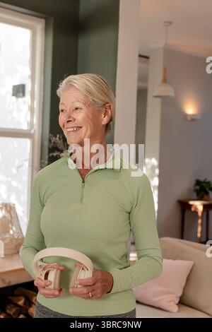 Woven basket with cushion on wooden floor inside a home Stock Photo - Alamy