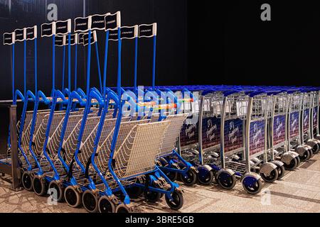 Helsinki, Finland, March 26th, 2025. Airport shopping carts with the ...