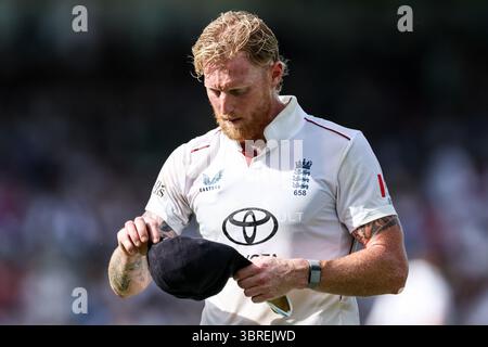 England captain Ben Stokes puts his hat on after blowing an over during ...