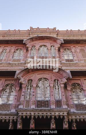 Detail of the intricately carved red sandstone arched entrance with ...