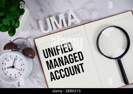 Unified Managed Account (UMA) text on notepad, Business and Financial ...