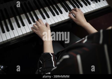 Beautiful asian girl learn to play piano Stock Photo - Alamy