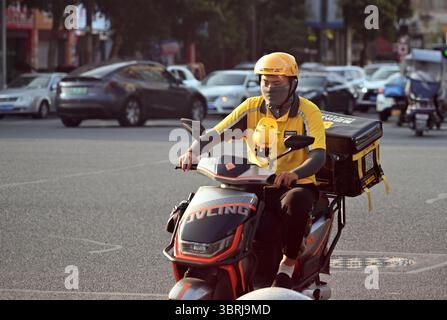 A Courier is working in high temperatures in Neijiang City, Sichuan ...