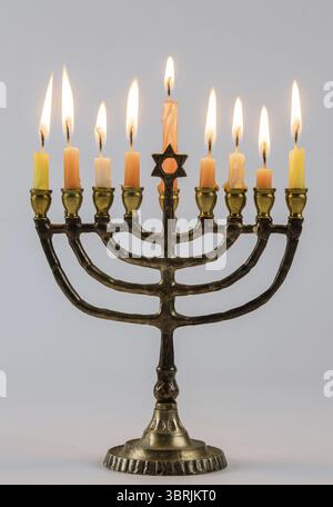 Closeup of a burning Chanukah candlestick with candles Menorah a ...