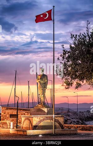 27 April 2025, Ciftlikkoy, Turkiye: Turkish flag waving over a statue ...