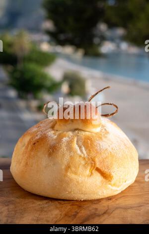 Fresh baked bread in burrata cheese shape filled with tomatoes ...
