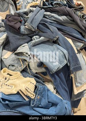 Casual Denim Pile with Mixed Textures and Cream Knit Accent Stock Photo ...