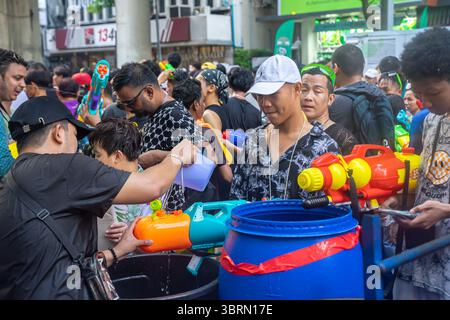 People with water guns celebrating the Thai new year of Songkran in ...