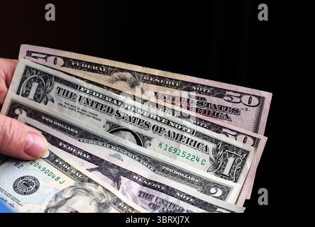 In this photo illustration a 1 dollar bill with various dollar bills ...
