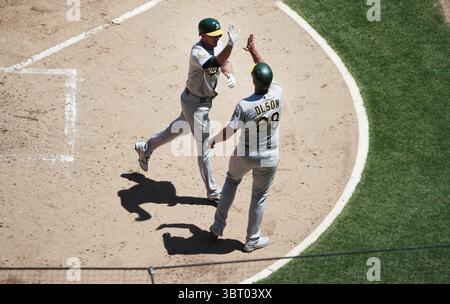Oakland Athletics' Matt Olson, left, waits for the throw from catcher ...