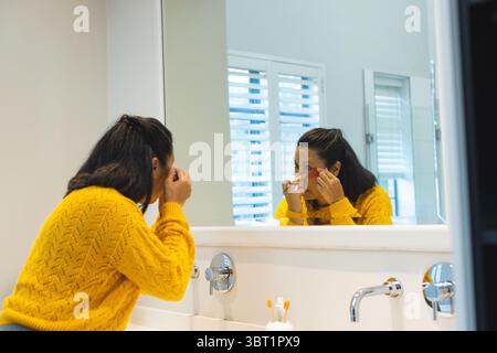 Woman Applying Under Eye Patches Stock Photo - Alamy