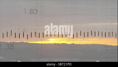 Glowing sun peeking through the clouds at sunset in a twilight blue sky ...