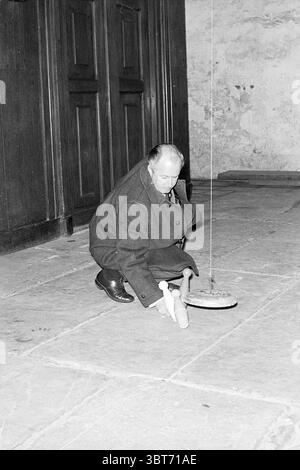 A man kneeling on the ground at a makeshift memorial near Wang Fuk ...