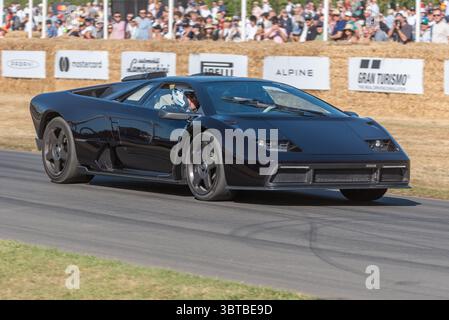 Eccentrica V12 sports car driving up the hillclimb track at the ...