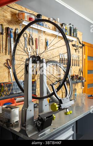 Bicycle wheel tuning station in workshop Stock Photo - Alamy