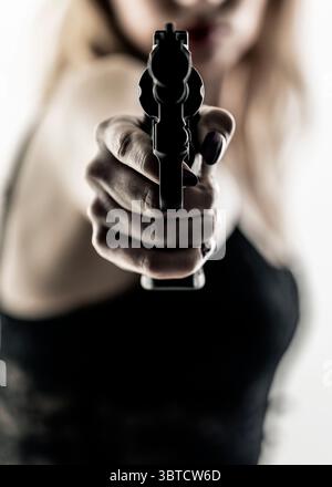 A black gun with the barrel pointing directly towards the camera on a ...