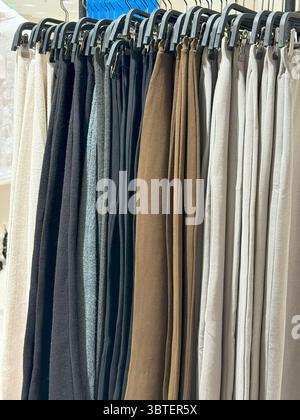 Assorted Pants on Hangers ,Earth Toned Retail Display Stock Photo - Alamy