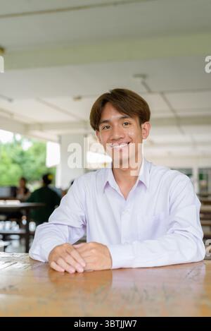 Non binary Asian university student in college campus Stock Photo - Alamy