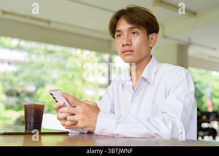 Non binary Asian university student in college campus Stock Photo - Alamy
