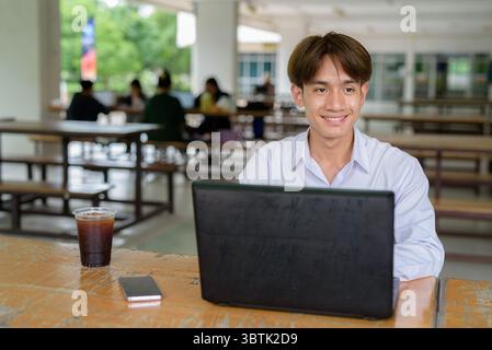 Non binary Asian university student in college campus Stock Photo - Alamy