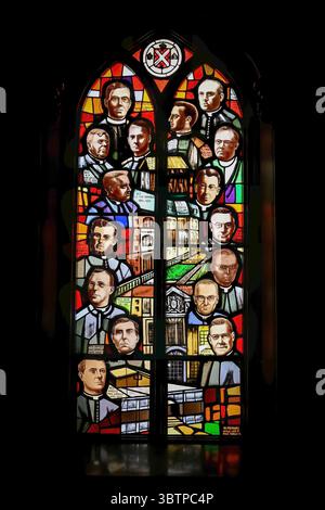 An ornate glass window surrounded by a decorative arch built in to the ...