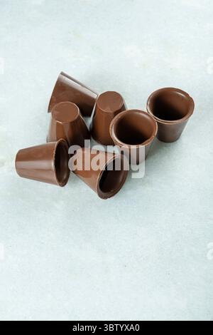 Several cone-shaped milk chocolate shells top view vertical Stock Photo ...