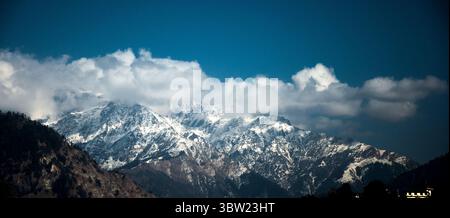 A scenic view of a mountain range partially covered with snow under the ...