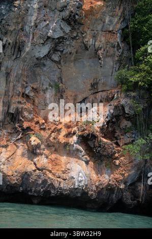 Vibrant colours seen on limestone cliffs on a small, uninhabited island ...