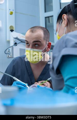Medical workers wearing protective gear prepare to take sample during a ...