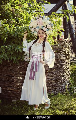 A brunette Caucasian woman with crown in princess mode on a white ...