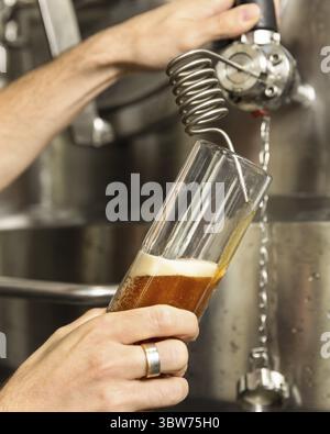 Man pouring, filling beer glass, mug Stock Photo - Alamy