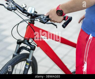 Man red bike handle grips close up Stock Photo - Alamy