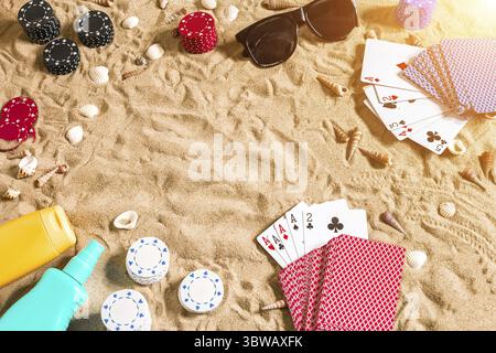 Beachpoker. Chips and cards on the sand with seashells. Top view Stock ...