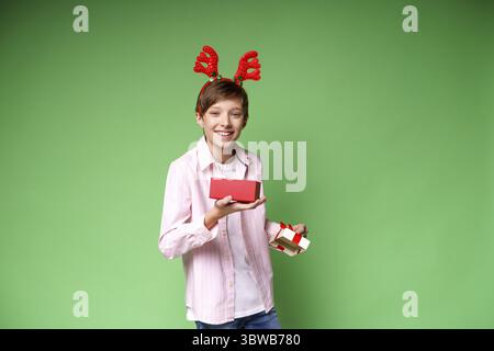 Teenager child with gift box, studio isolated background. Present for ...